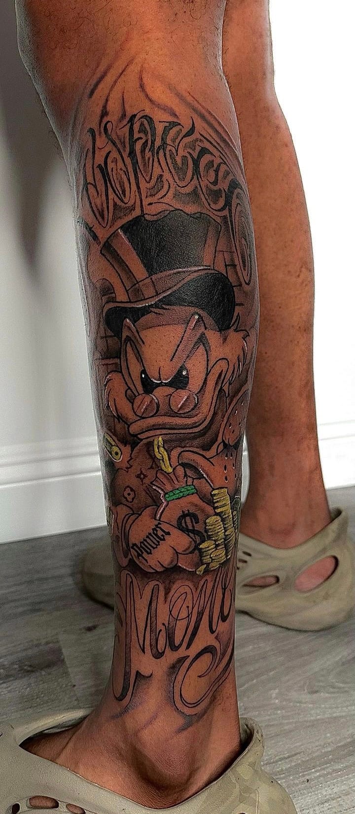 Donald Duck Tattoo on Lower Leg on Darker Skin Tone - Best tattoo shop ...